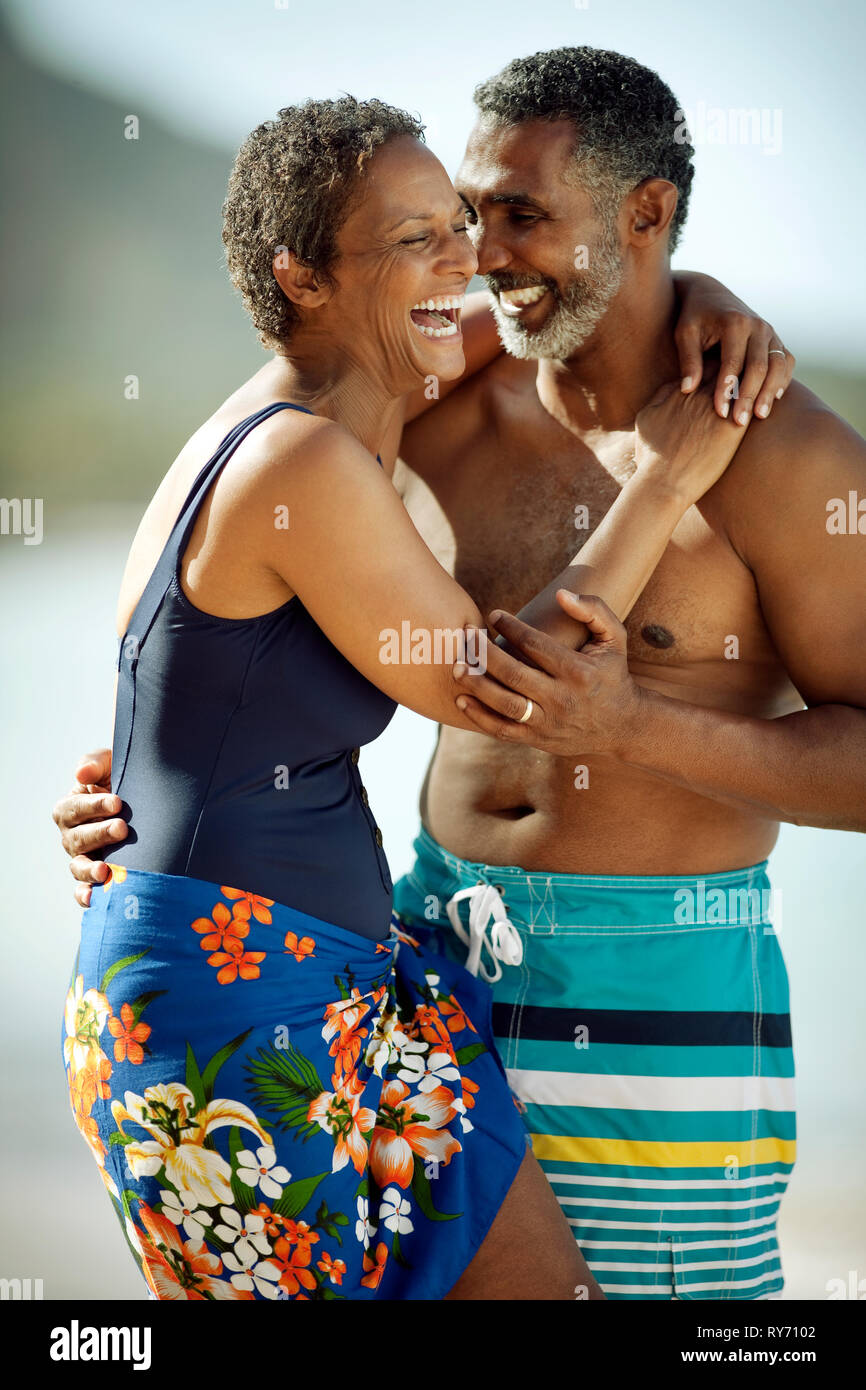 Couple hugging at beach, wearing swimwear Stock Photo - Alamy