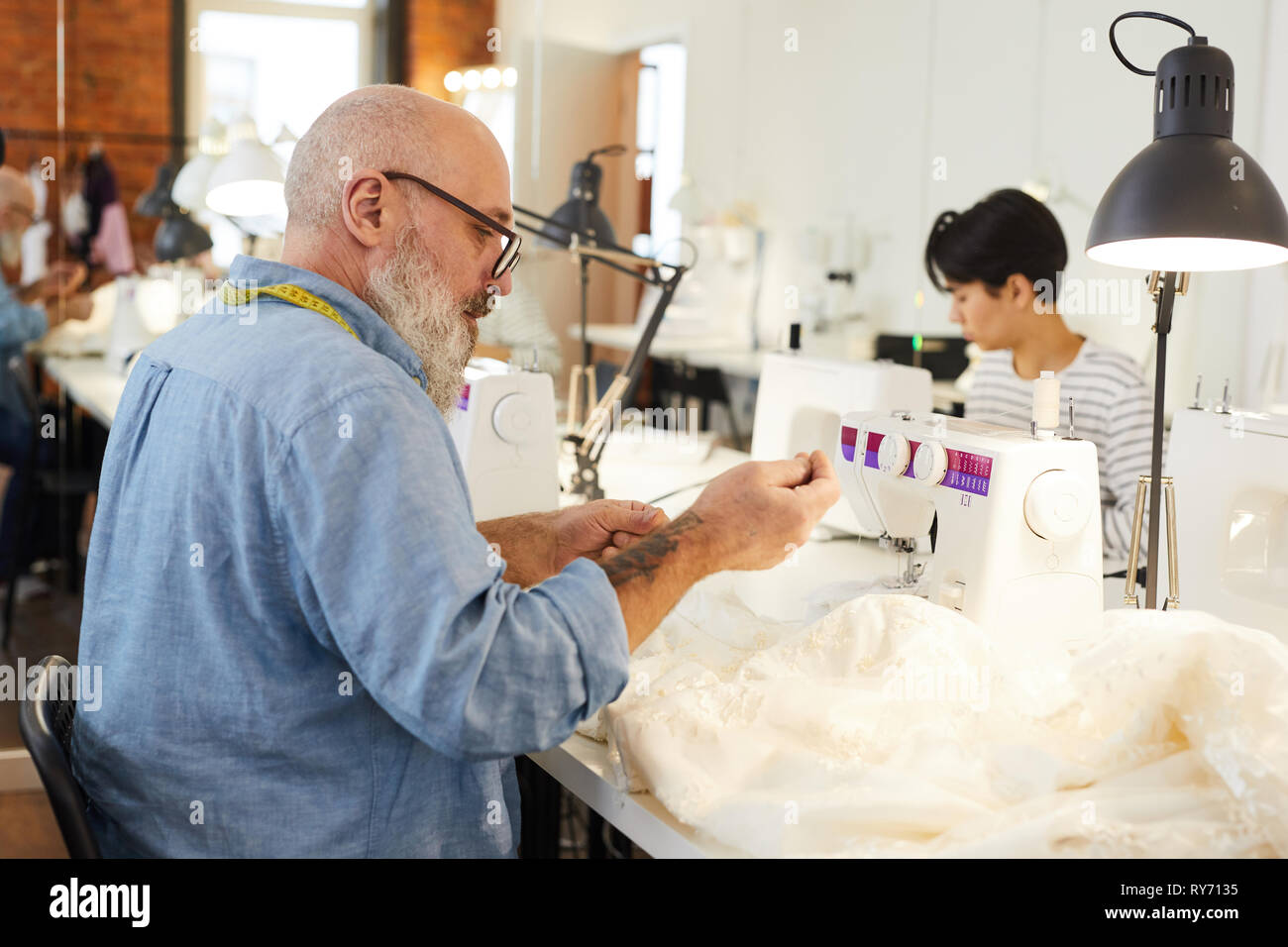 Using sewing machine Stock Photo - Alamy