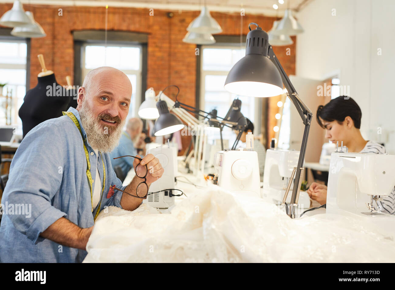 Man sewing clothes Stock Photo - Alamy
