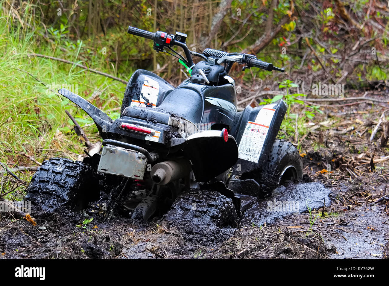 Closeup of a quad stuck in mud Stock Photo - Alamy