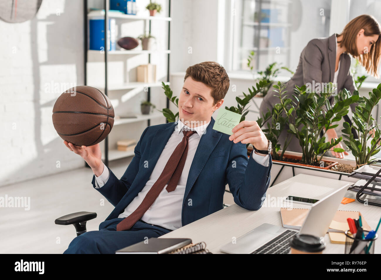 selective focus of businessman holding sticky note with later lettering ...