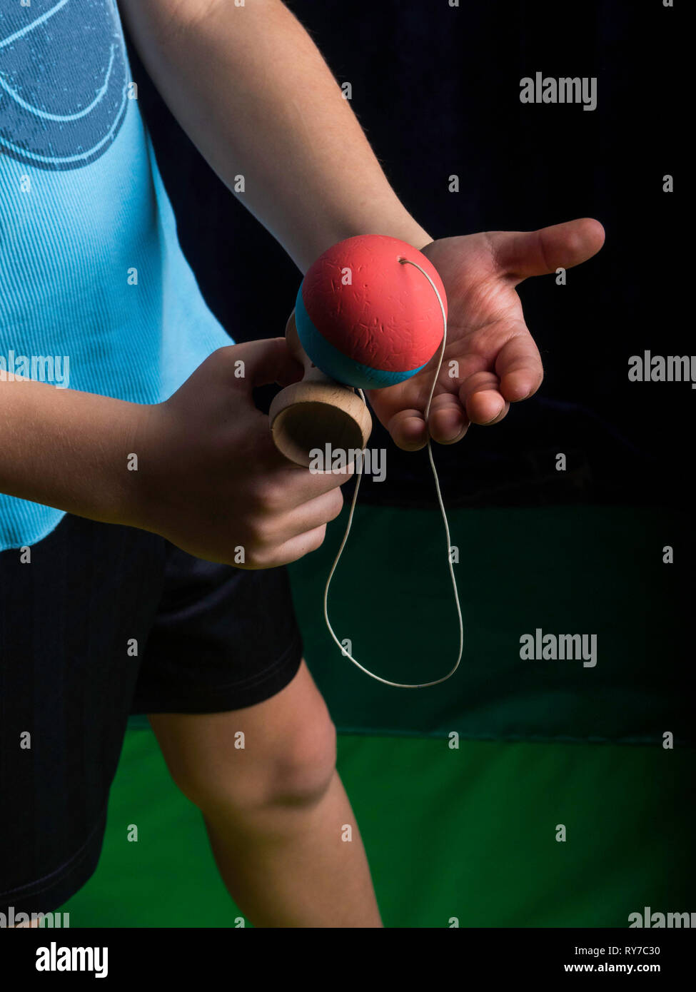 boy playing wooden kendama, classic japanese game Stock Photo - Alamy