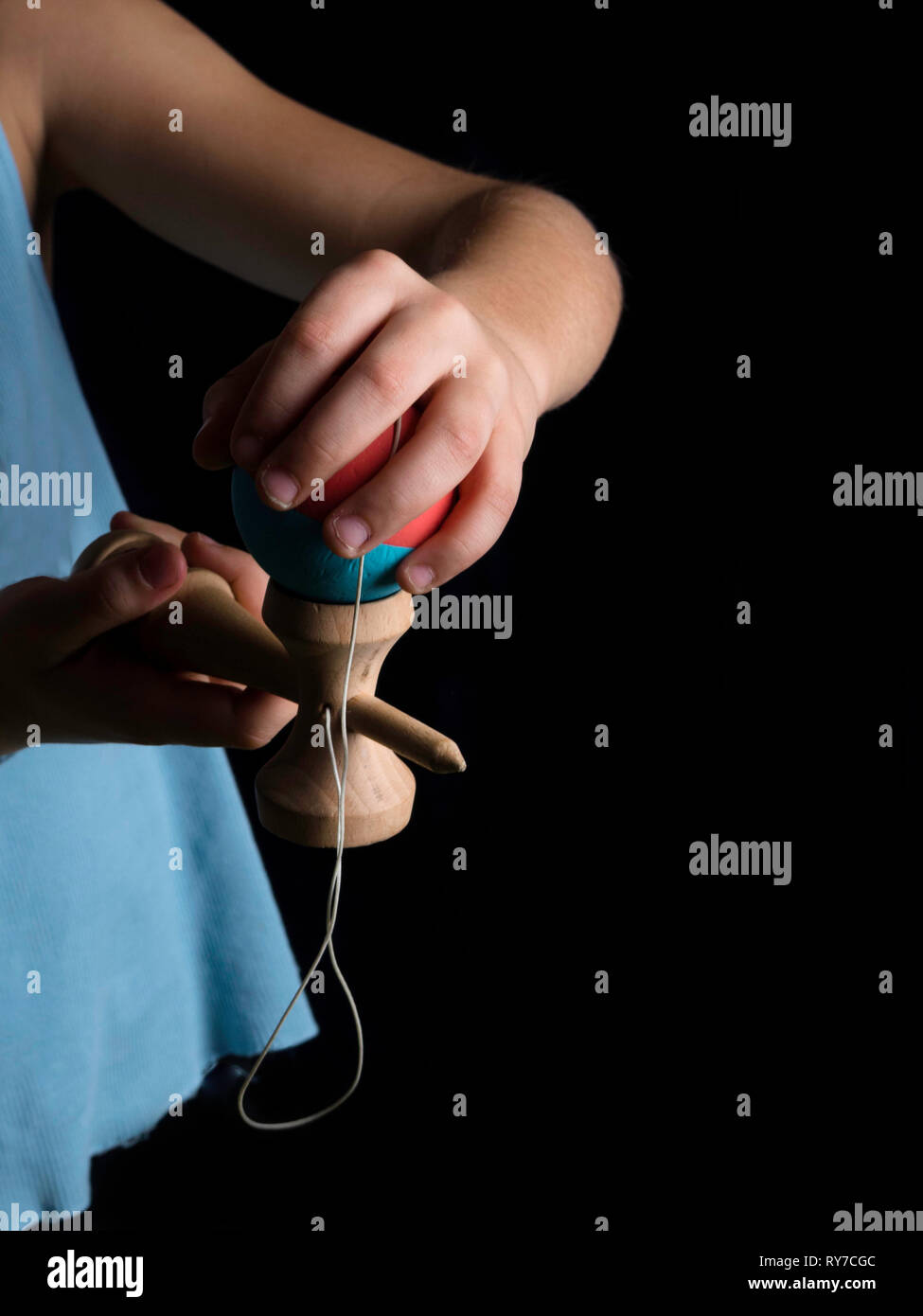 Classic Japanese game kendama, boy hands playing with wooden color ...