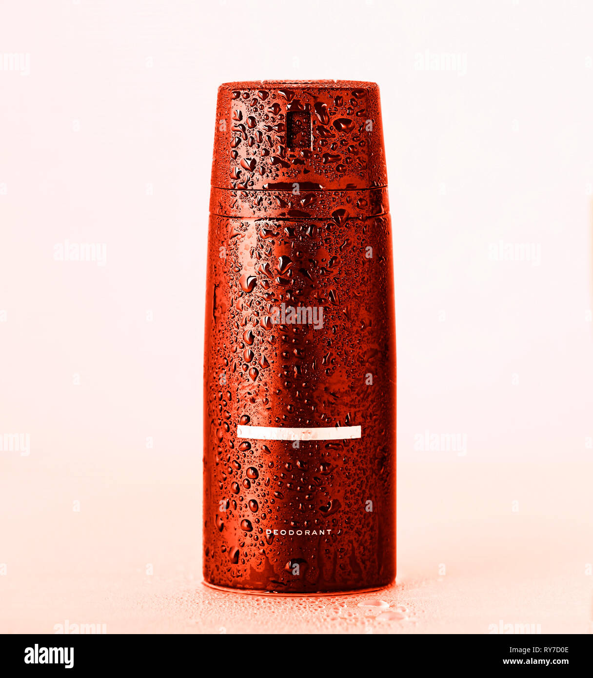 red-gold bottle aerosol deodorant shower gel with water droplets on the ...