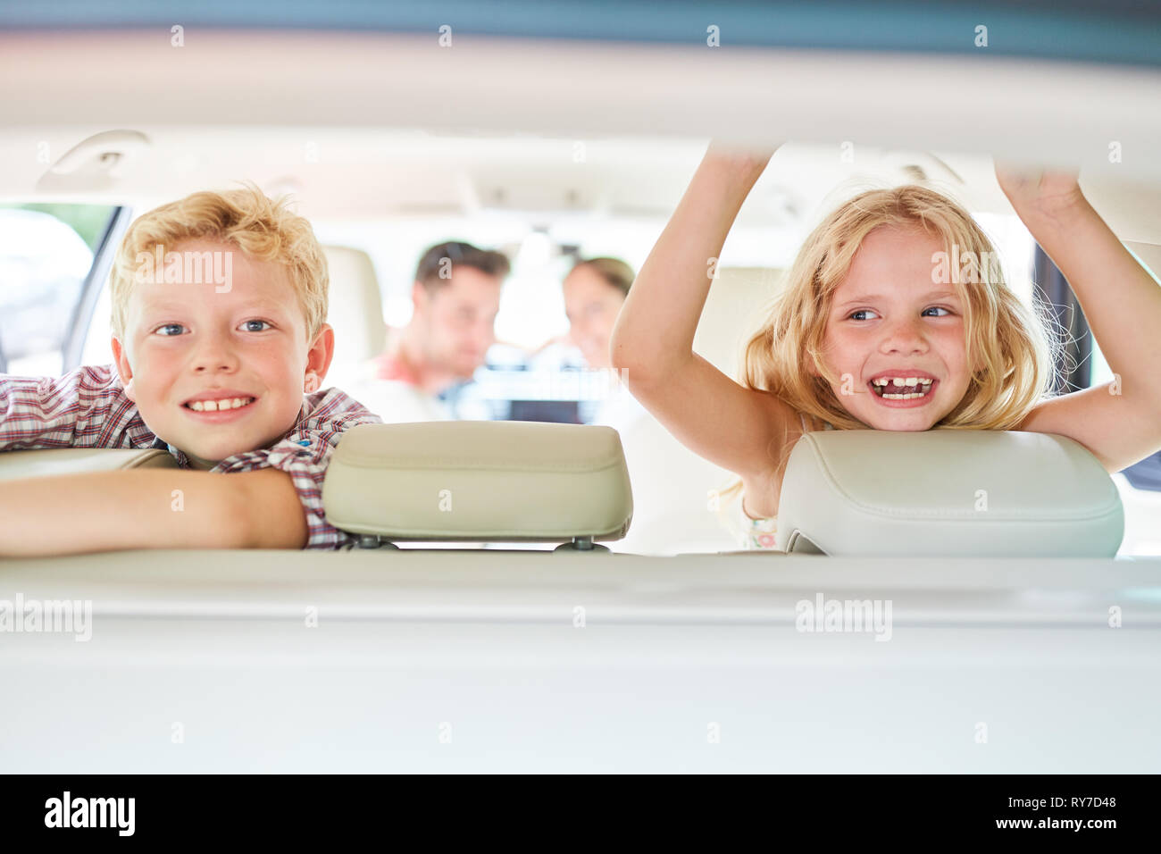 Two children in back seat in the car on family vacation Stock Photo - Alamy