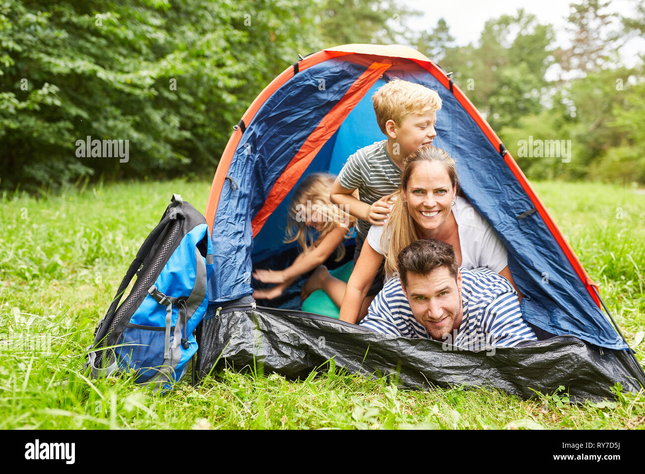 Family with two children camping on a summer campsite Stock Photo - Alamy