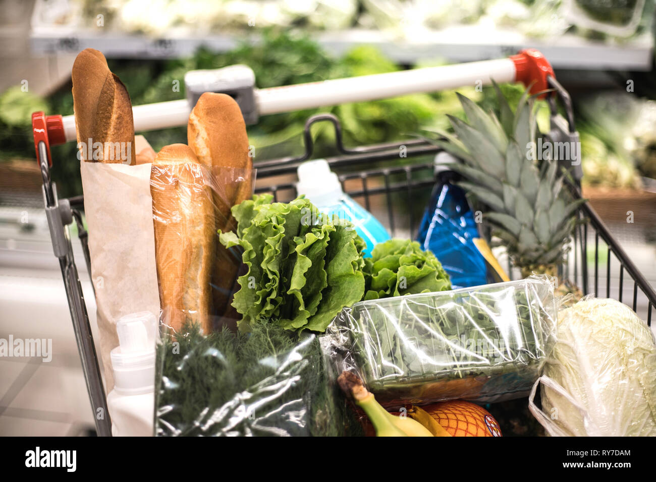 Full of products shopping trolley in supermarket Stock Photo - Alamy