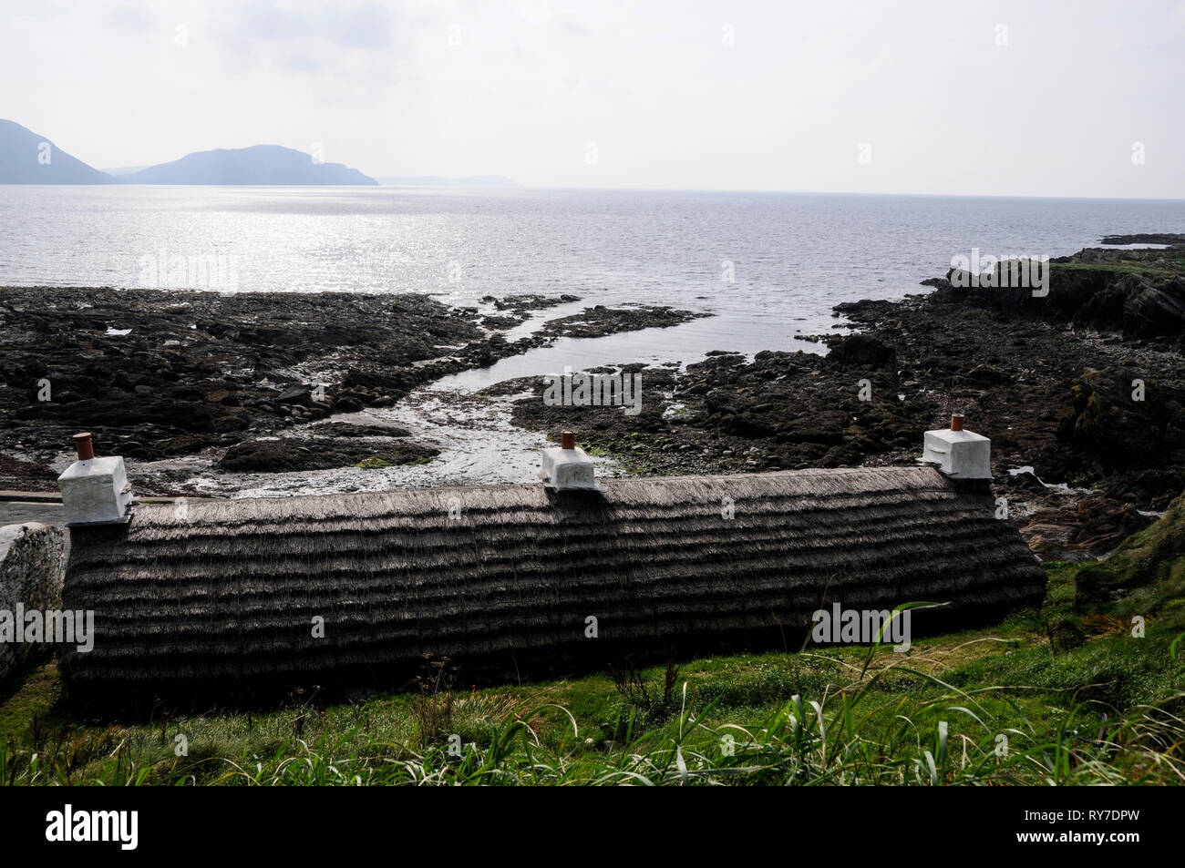 The Irish sea looking over the thatched roof croft at Niabyl on the ...