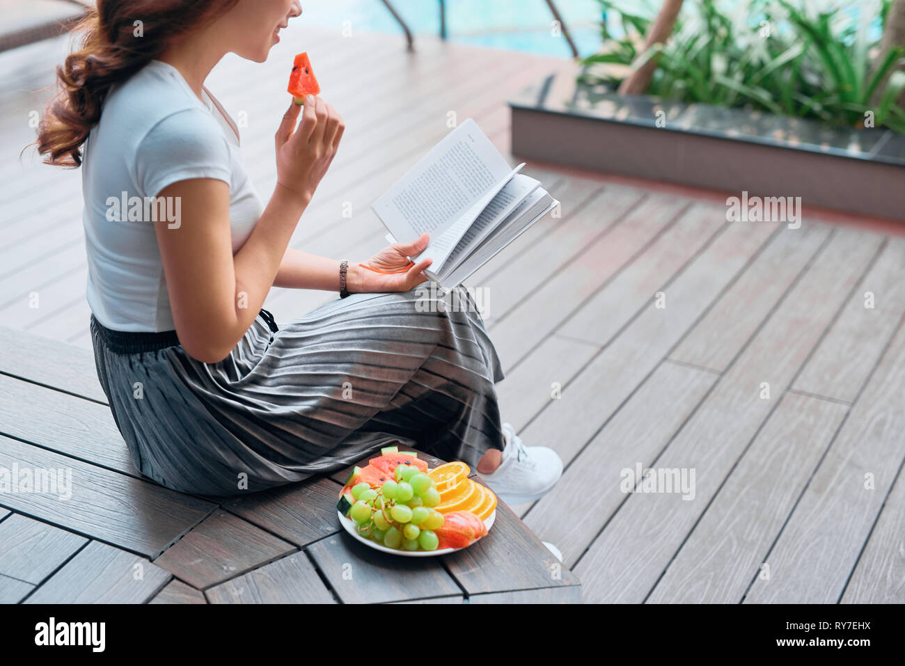 Woman reading in swimming pool hi-res stock photography and images - Alamy