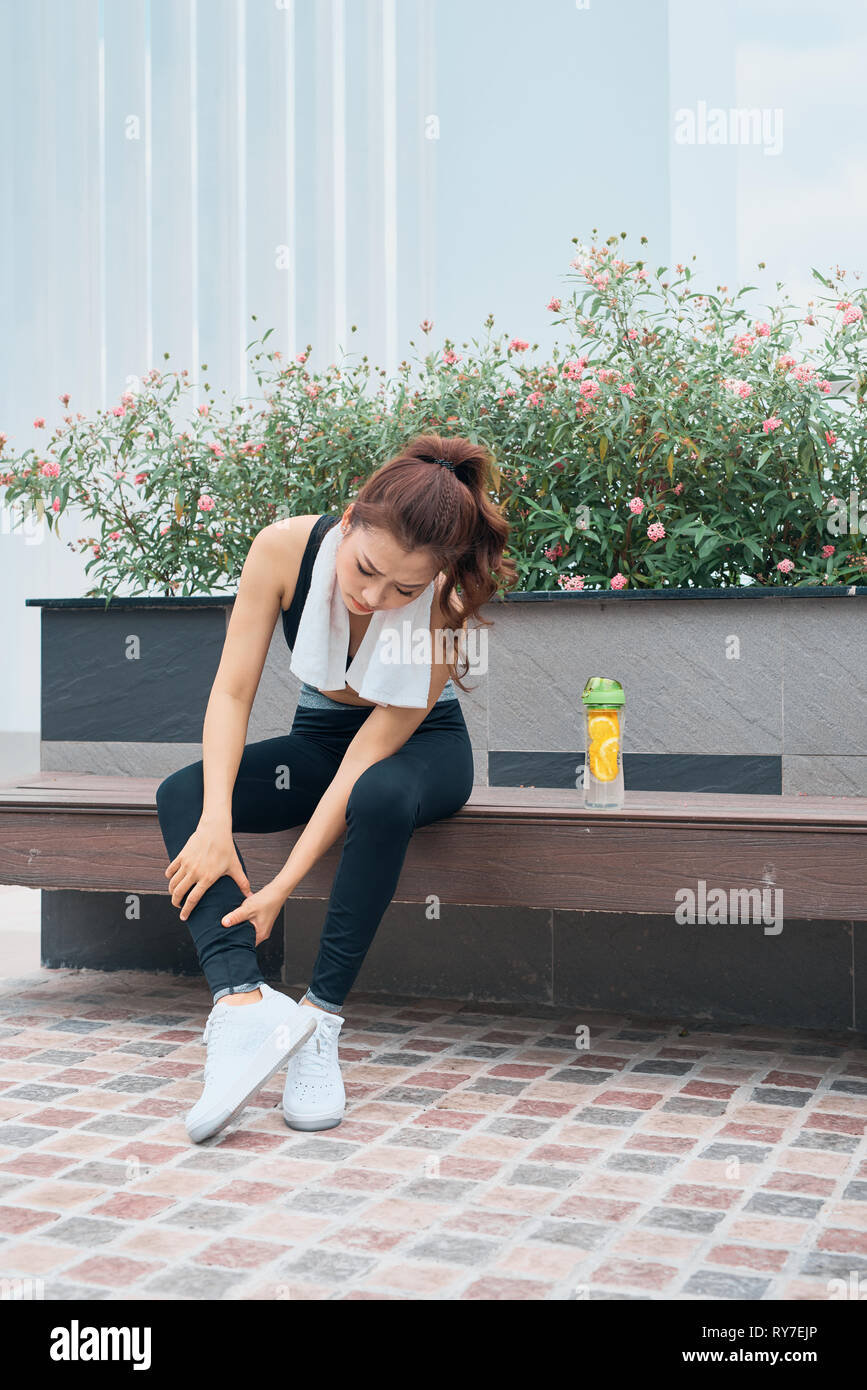 young beautiful and fit sport woman after running workout sitting on ...