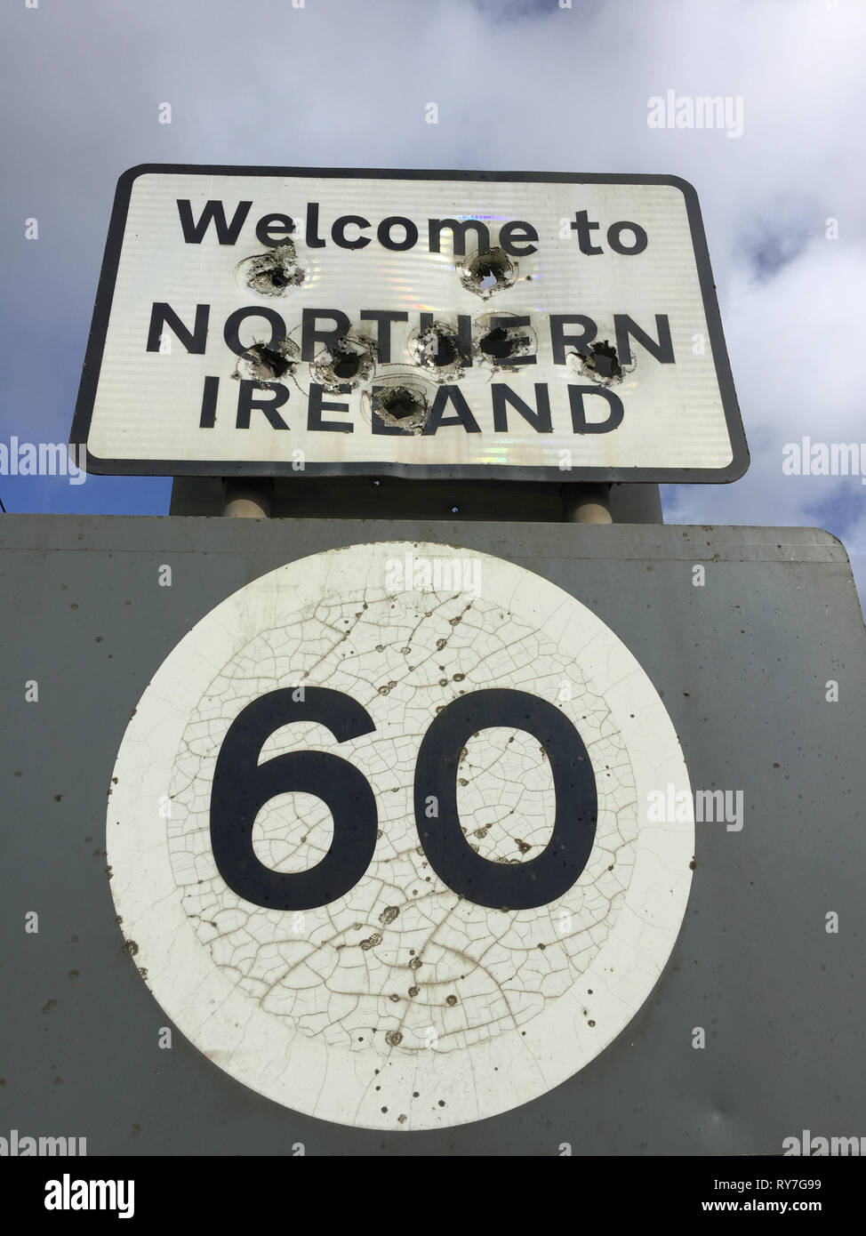 A bullet riddled welcome to Northern Ireland sign on the border between ...