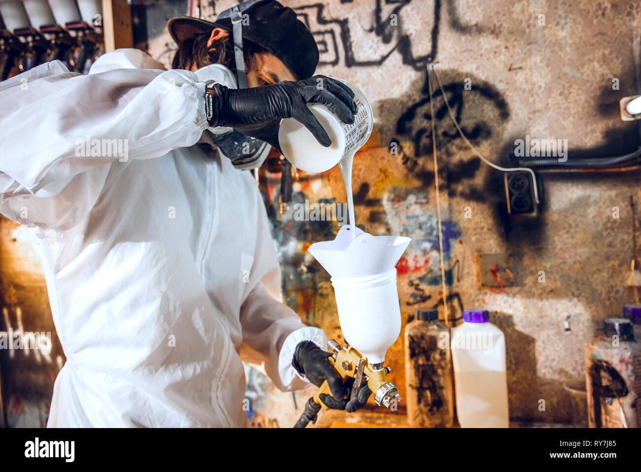 Master painter in a factory - industrial painting wood with spray gun ...