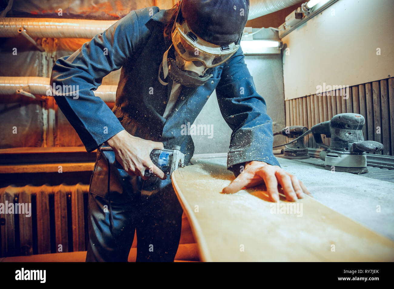 Worker using power sander hi-res stock photography and images - Alamy