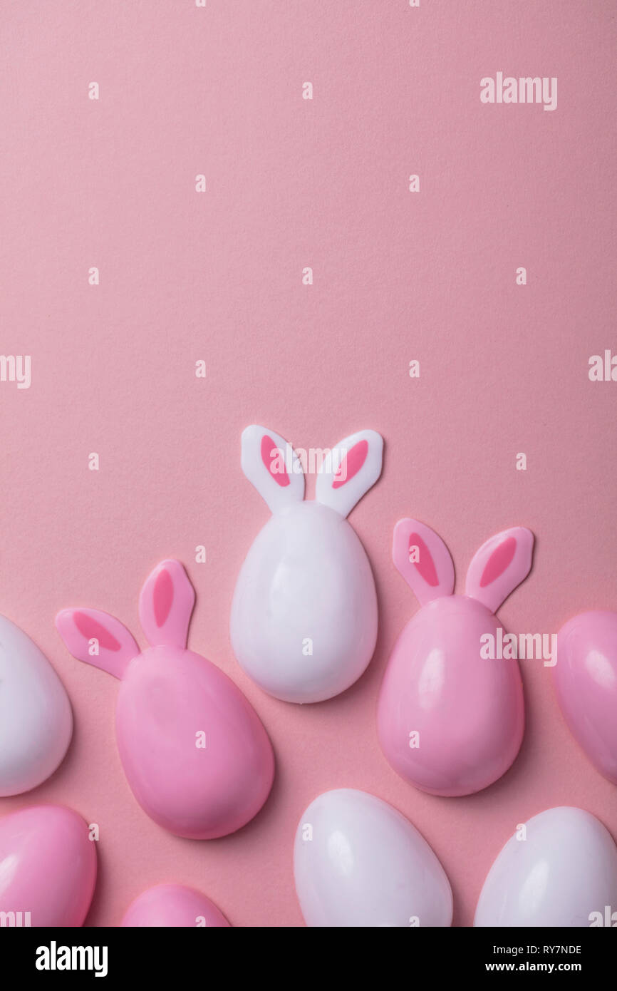 Easter eggs with bunny ears on a pastel pink background Stock Photo - Alamy