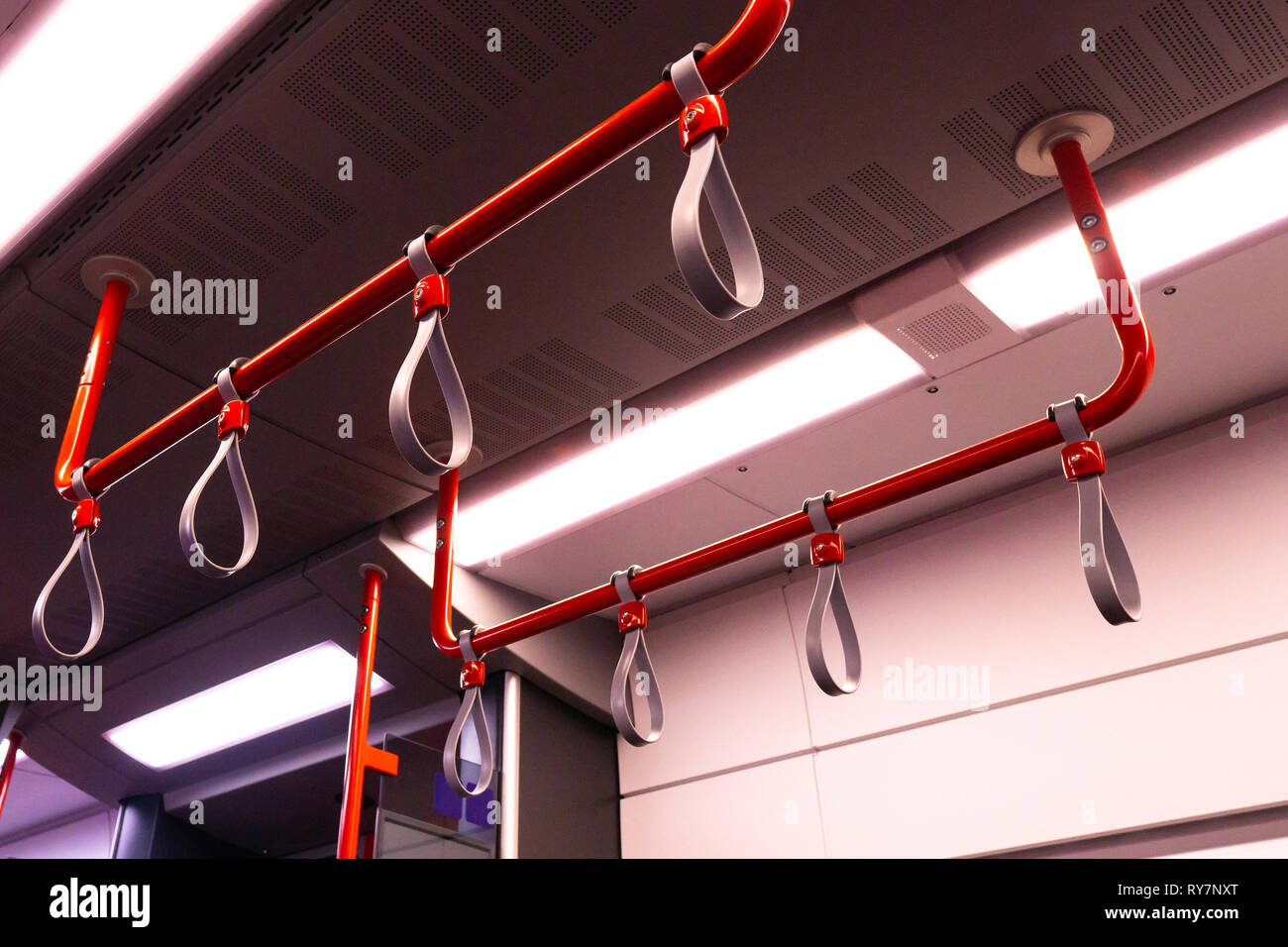 Four Train Ceiling Grey Colored Hand Straps Hanging on a Red Bar with ...