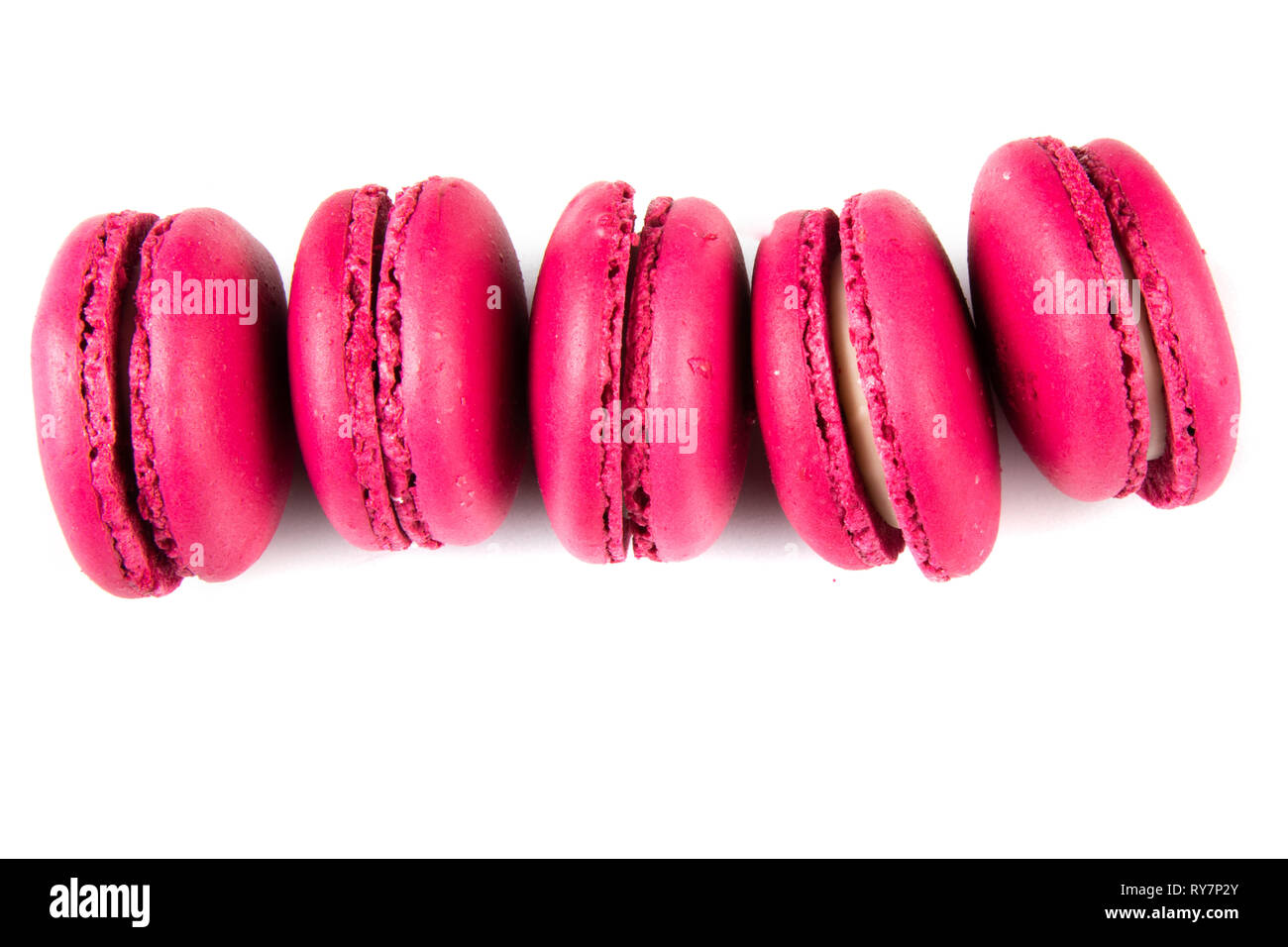 Red macaroons on a plain white background Stock Photo - Alamy