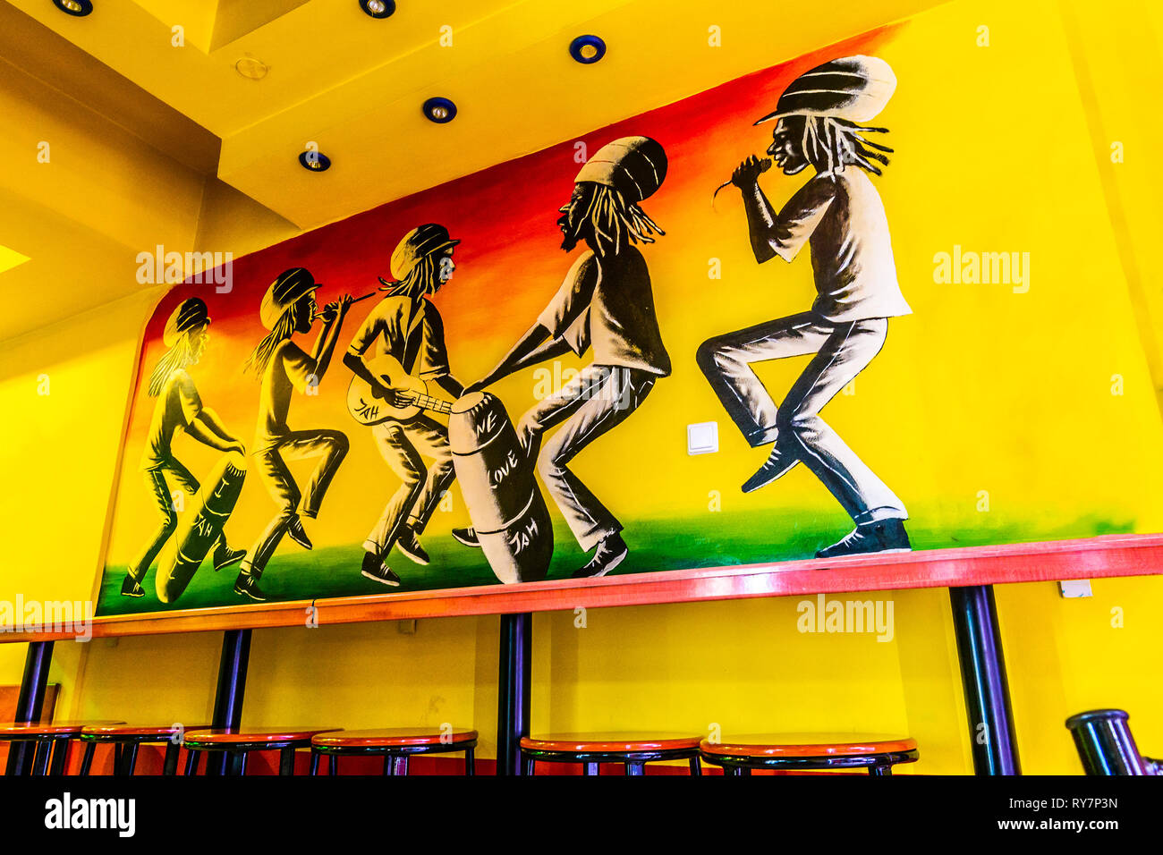 Depicted Five Dancing Reggae Jamaicans with Music Instruments on a Wall ...