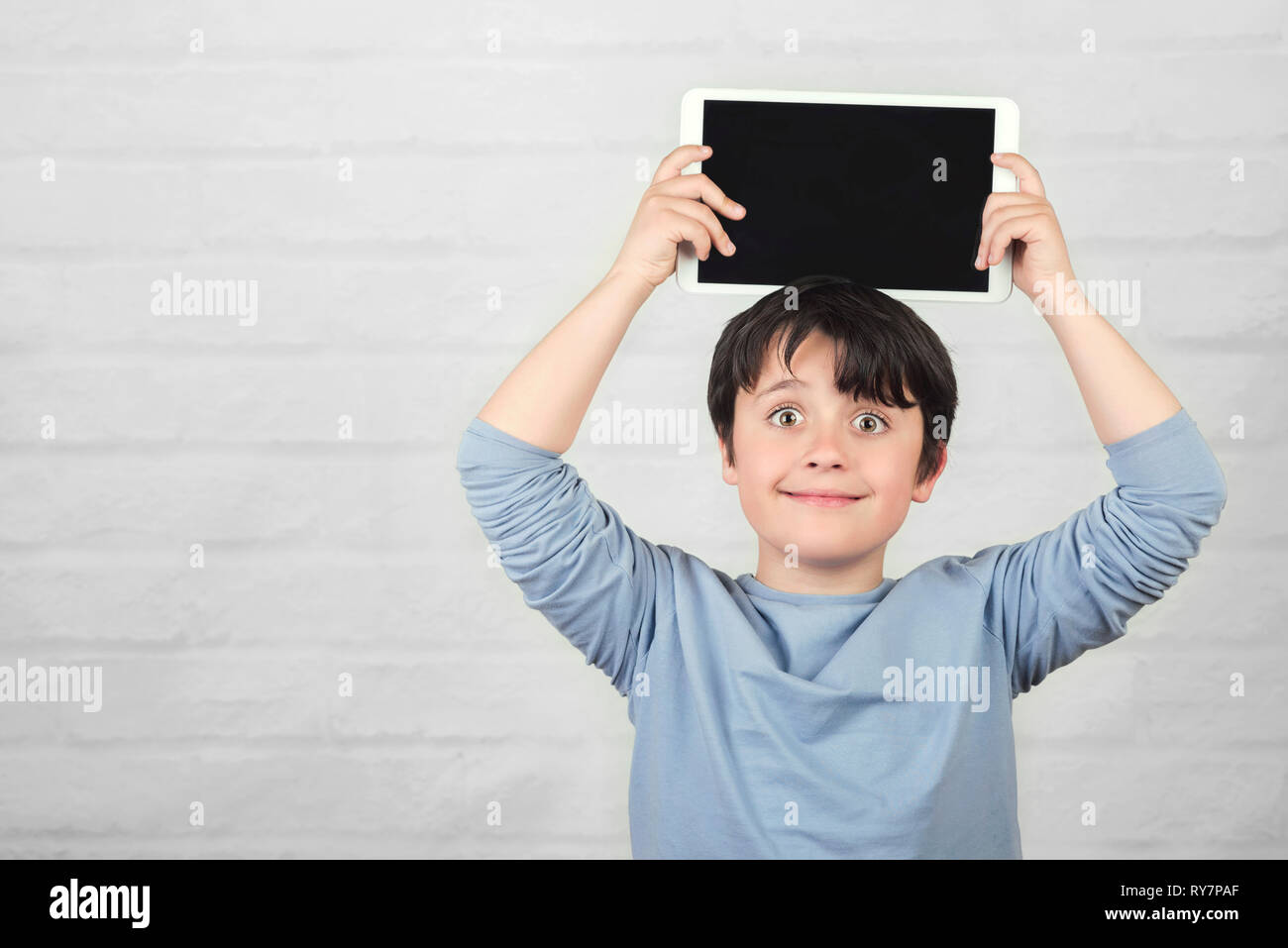 Tablet child holding screen hi-res stock photography and images - Alamy