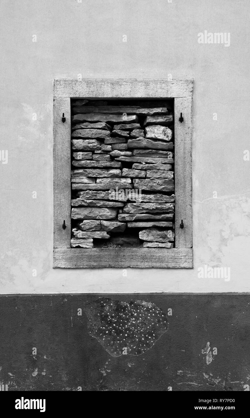 A window in a derelict building in the Croatian hill village of Bale ...