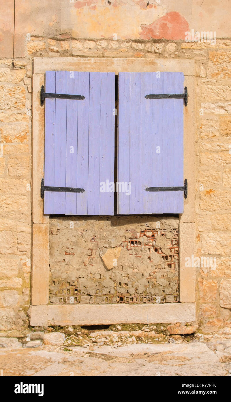 An old window space converted into a smaller window and covered with ...