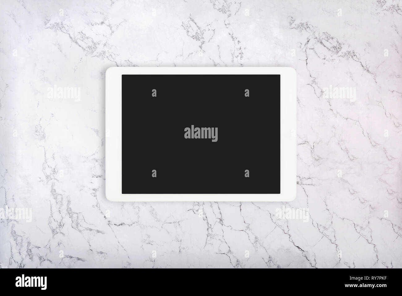 White touchpad on white marble texture. Tablet computer on marble ...