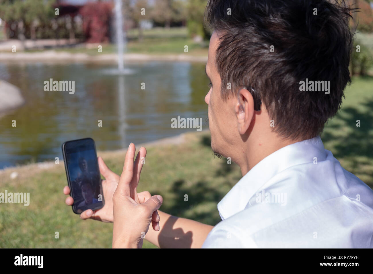 Young boy communicating with sign language at smart phone Stock Photo ...