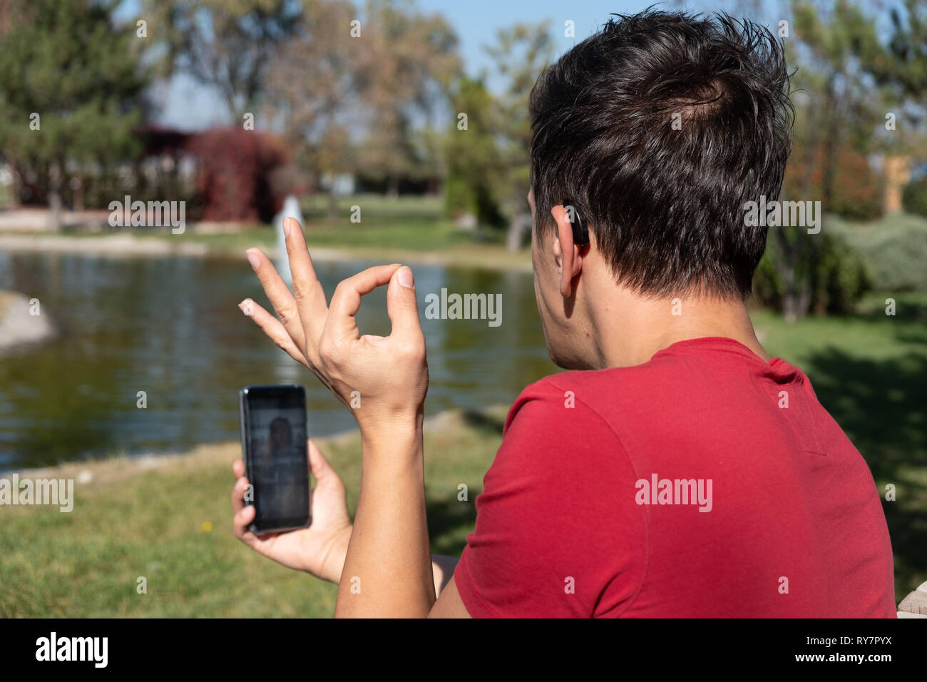 Young boy communicating with sign language at smart phone Stock Photo ...