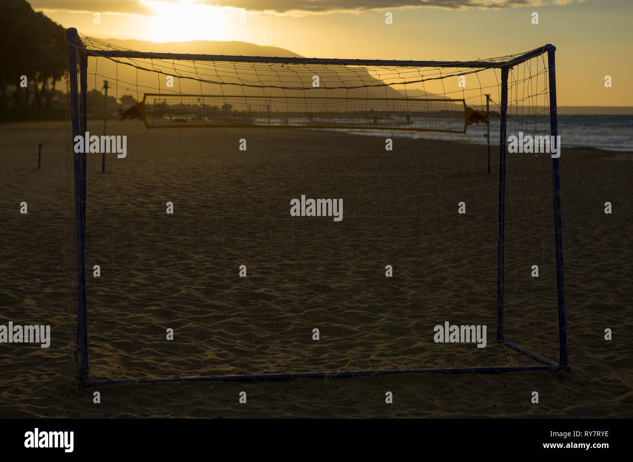 Goal and volleyball net on a beach Stock Photo - Alamy