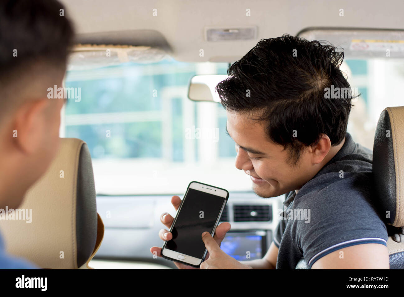 Online taxi driver showing smartphone for paying and give direction ...