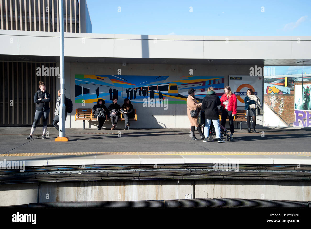 London. Hackney. Passengers wait on the platform at Hackney Wick ...