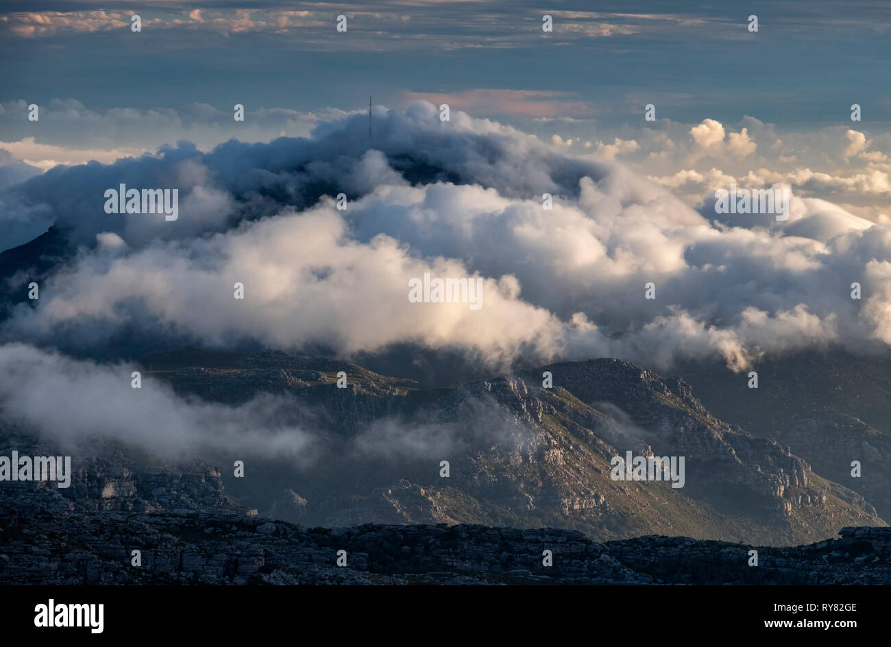 Cloud encased Constantiaberg Mountain viewed from Table Mountain, Cape ...