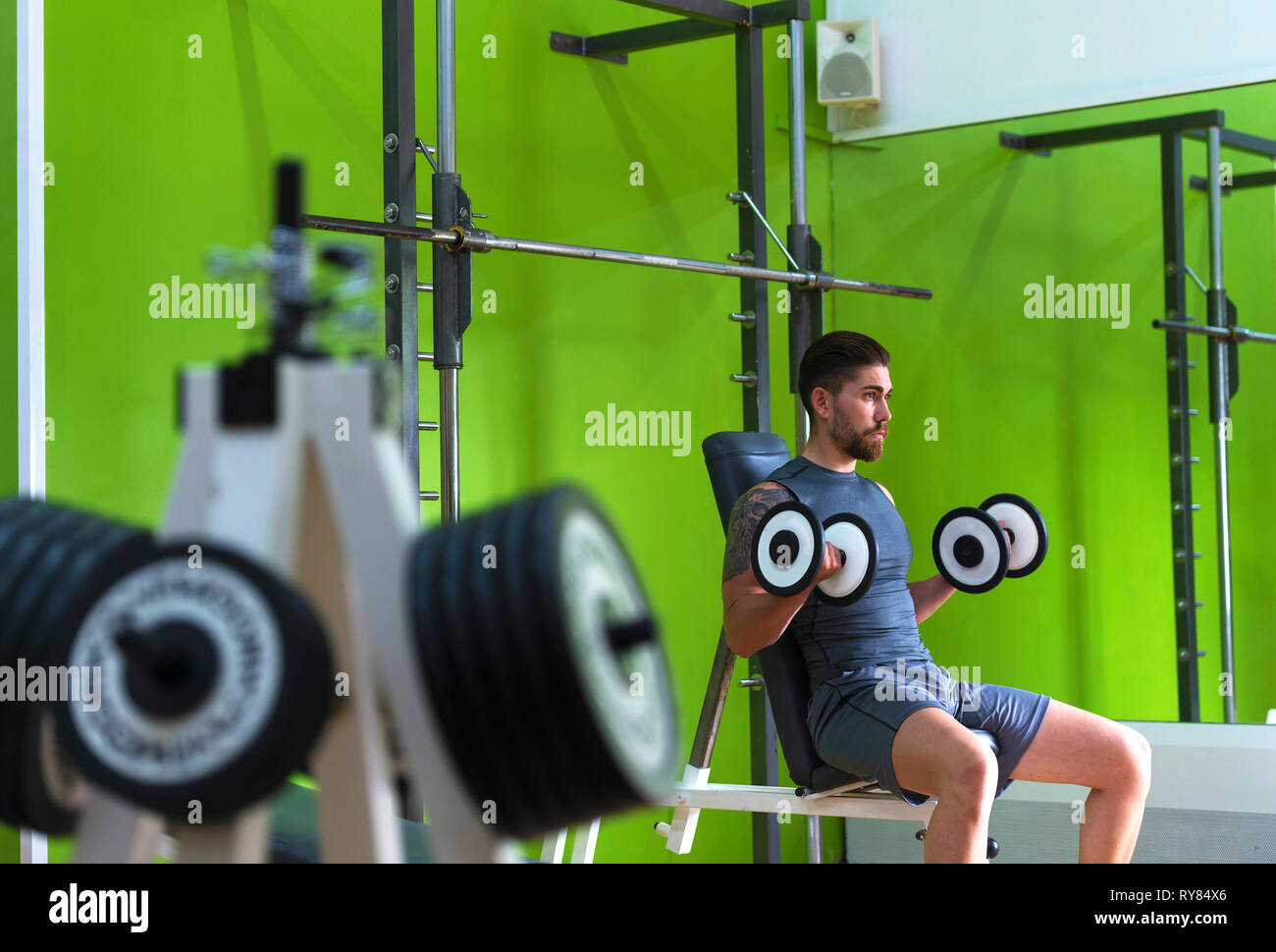 Hispanic man lifting weights hi-res stock photography and images - Alamy