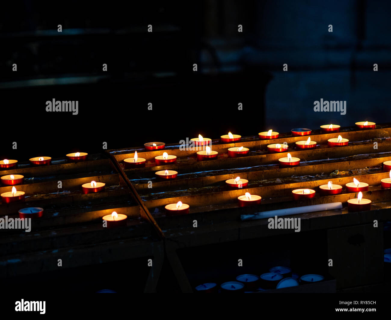 Low-light photograph of a lit candle in a Catholic church Stock Photo ...