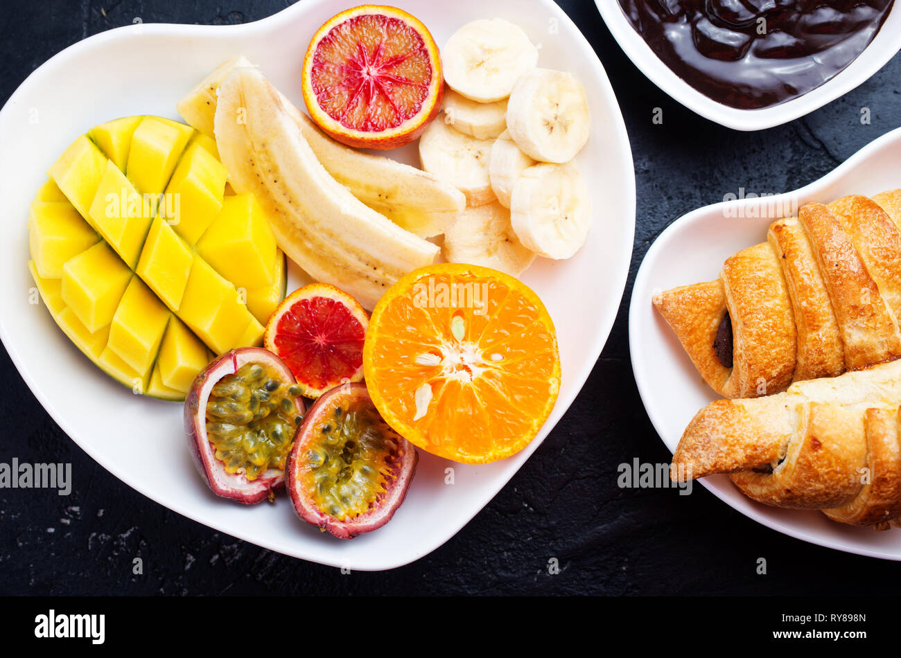 Healthy and fresh fruits on a plate Stock Photo - Alamy