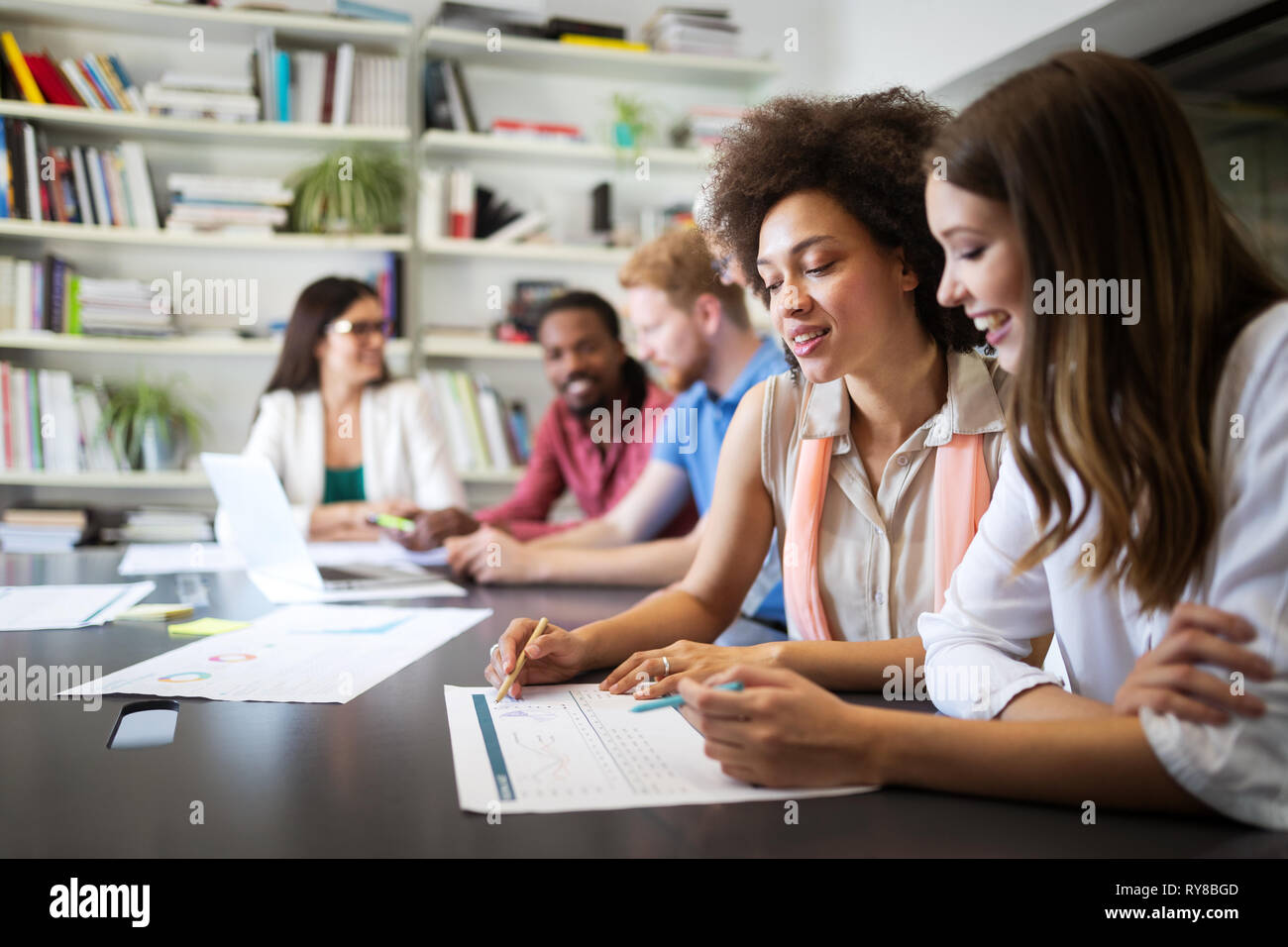 Team of colleagues brainstorming together while working in modern ...