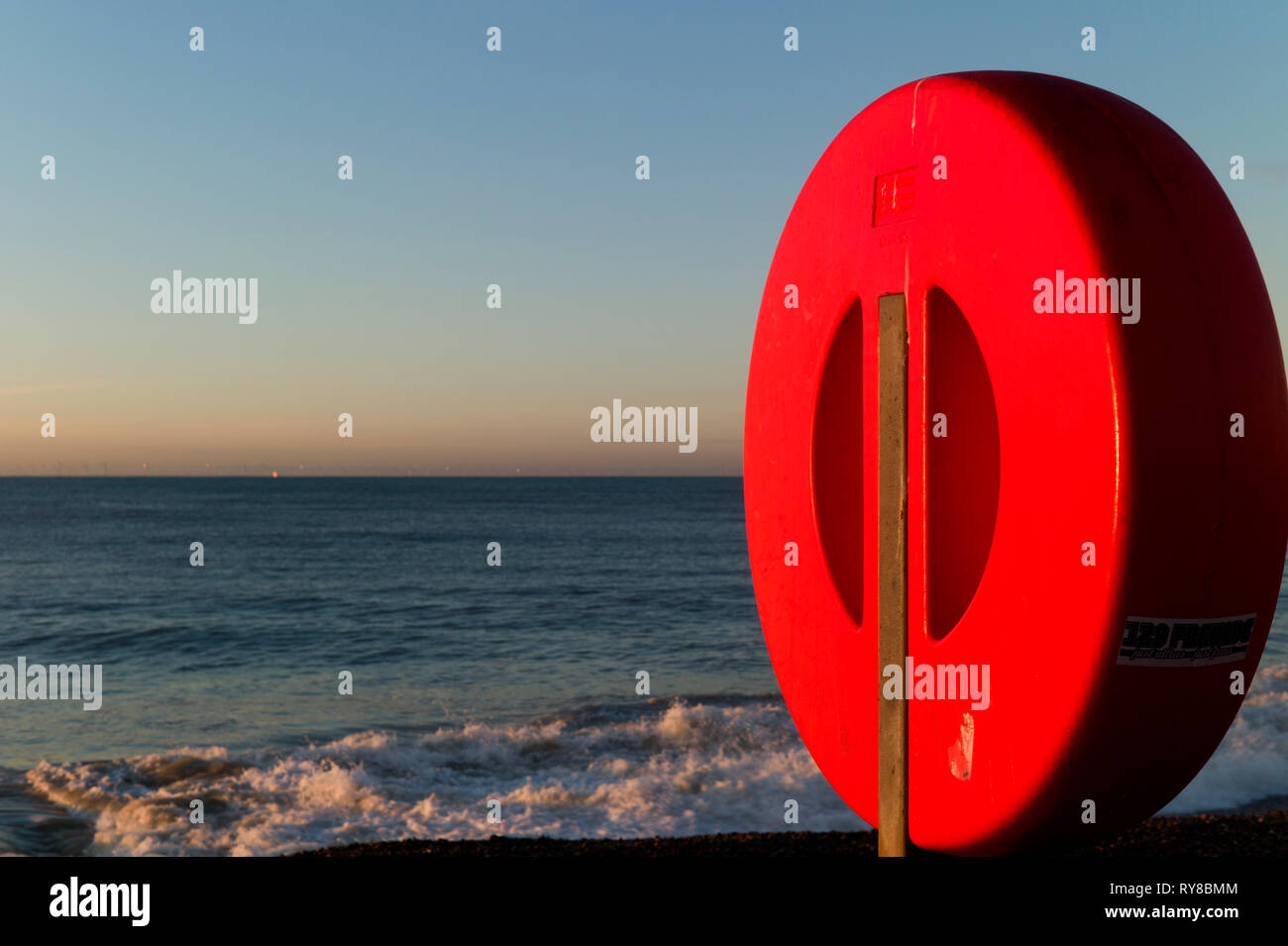 Red life buoy cover on beach, Brighton, UK Stock Photo - Alamy