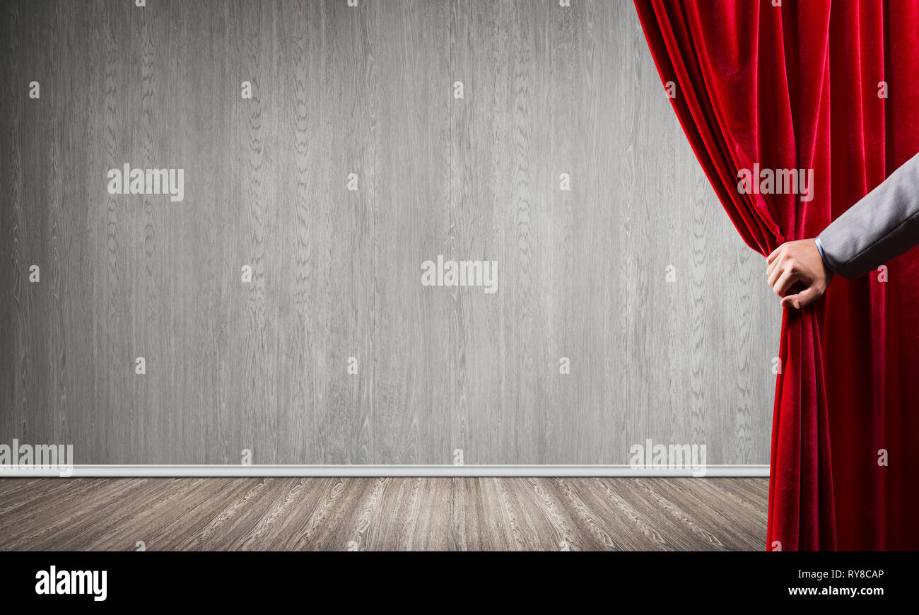 Concrete wall behind drapery curtain and hand opening it Stock Photo ...