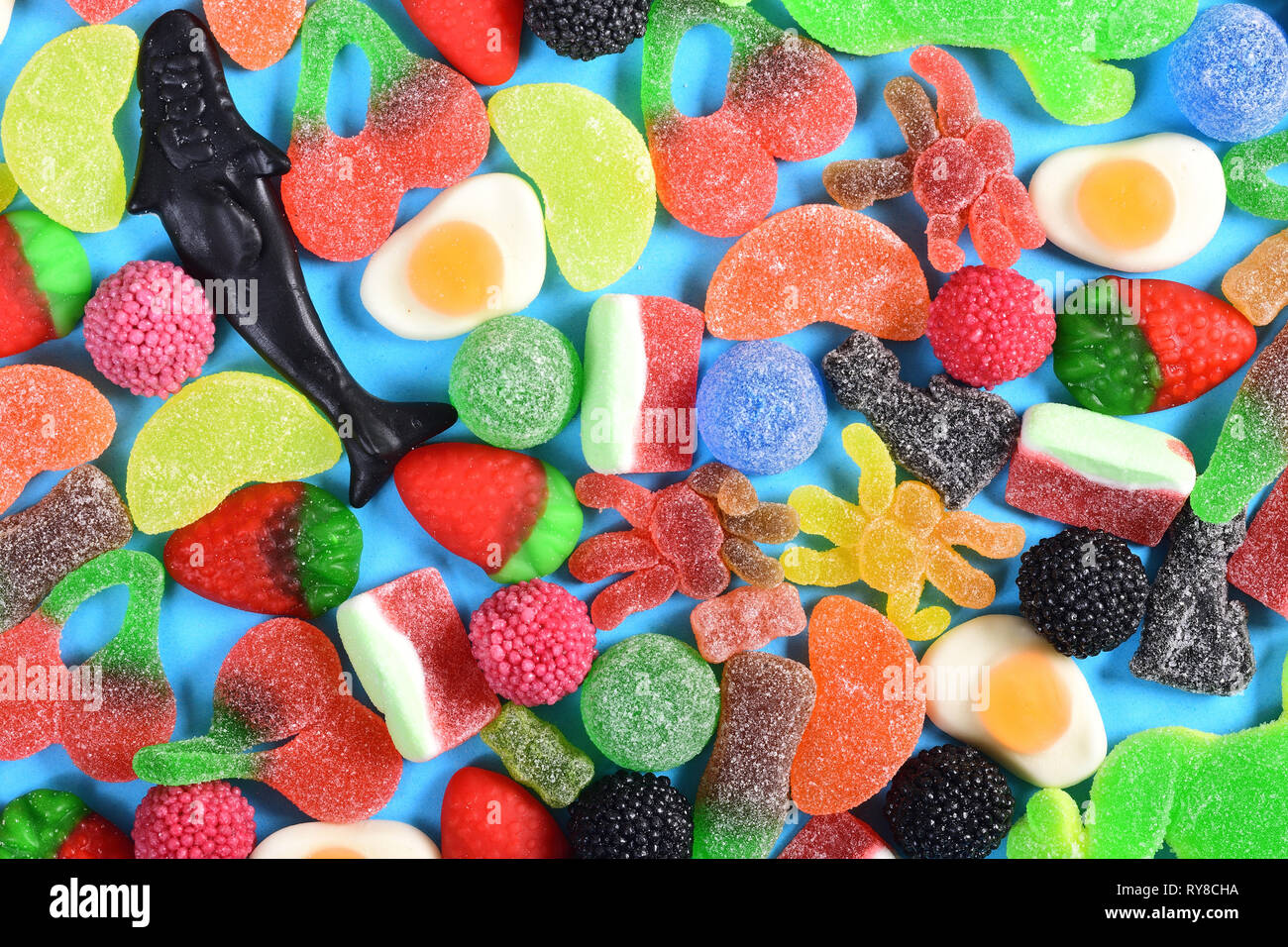 top view of jelly candies collection on blue background Stock Photo - Alamy