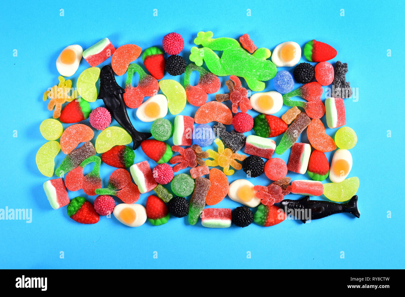 top view of jelly candies collection on blue background Stock Photo - Alamy