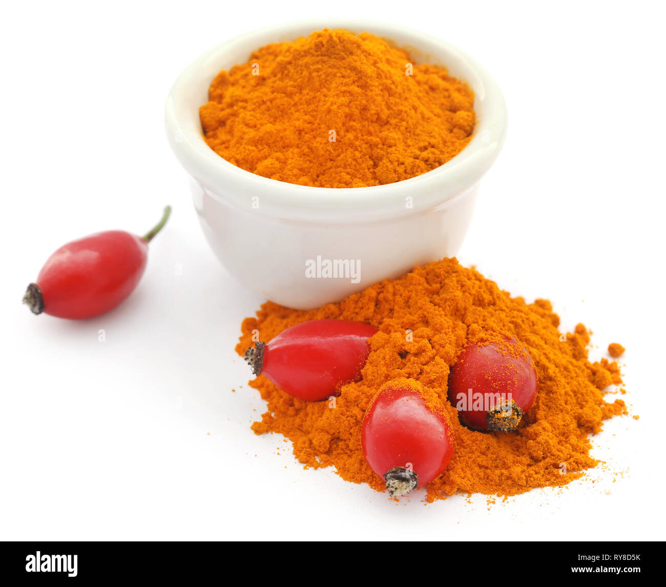 Rose hip powder with fruits, medicinal herbs over white background ...