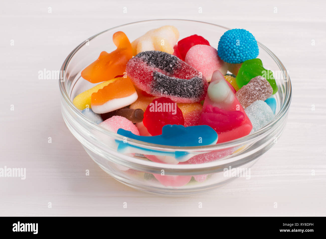 Glass bowl full of colorful candies Stock Photo - Alamy