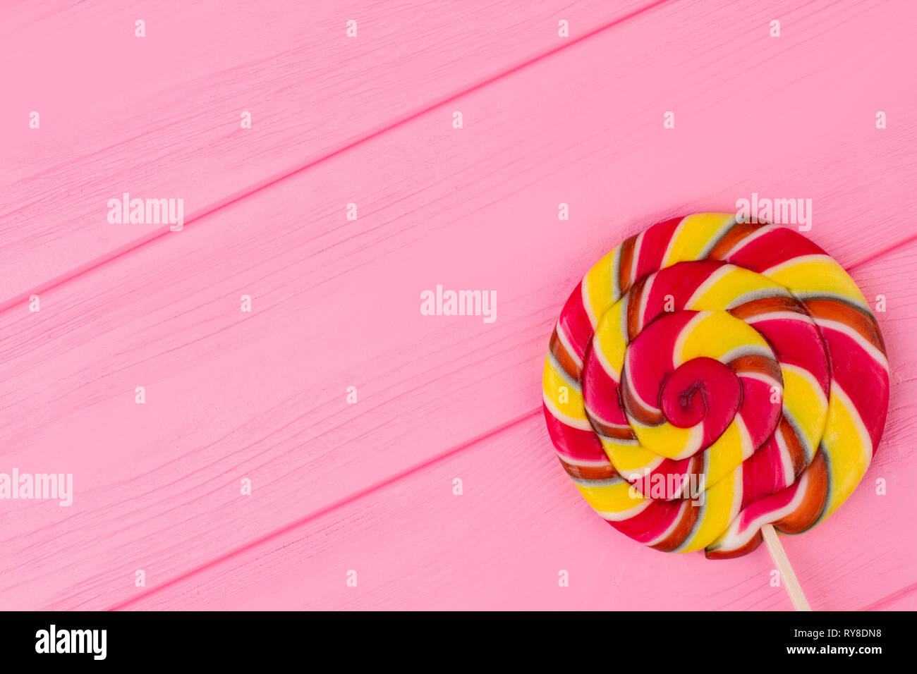 Colorful spiral lollipop candy on stick Stock Photo - Alamy