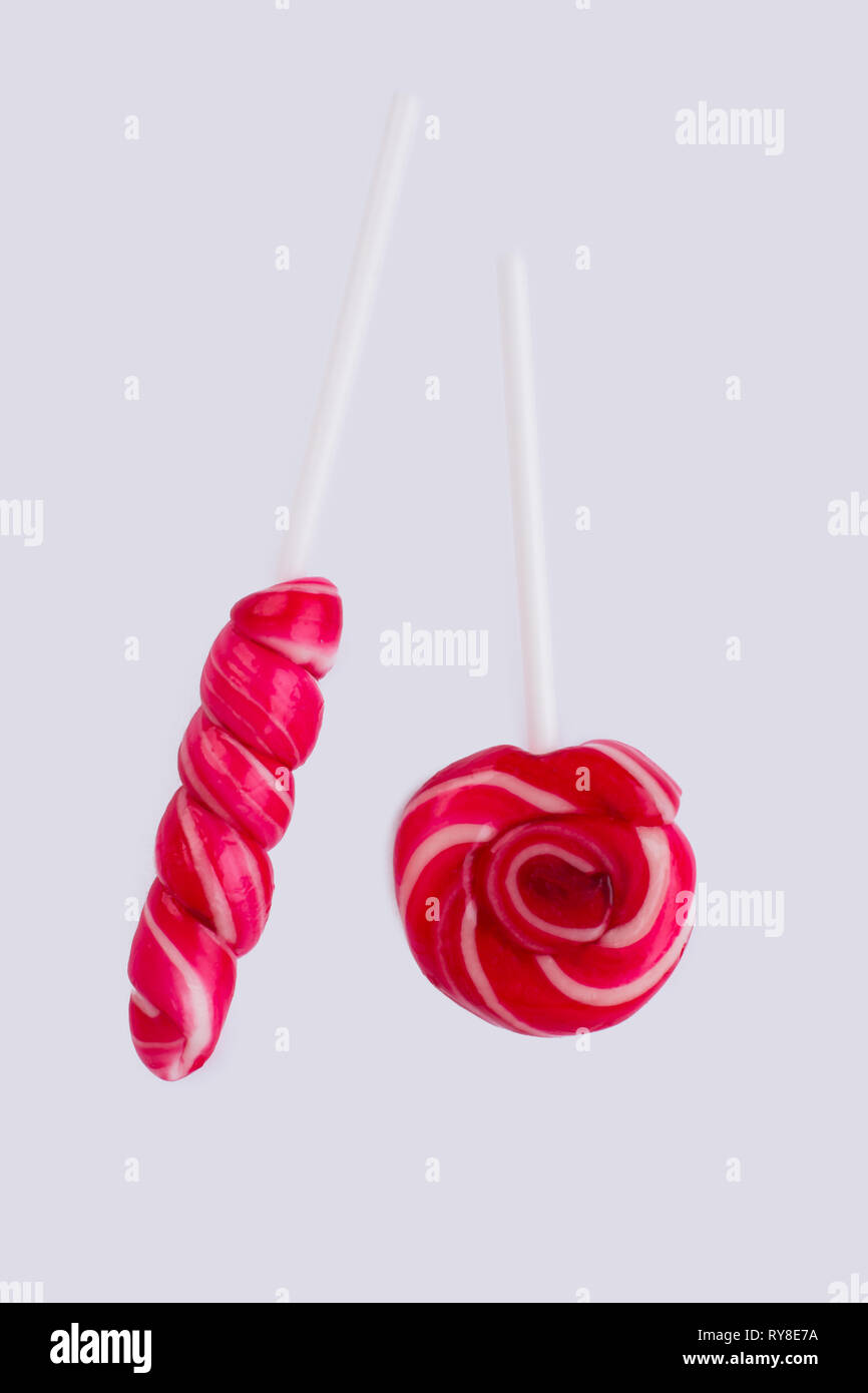 Swirl red lollipops on white background Stock Photo - Alamy