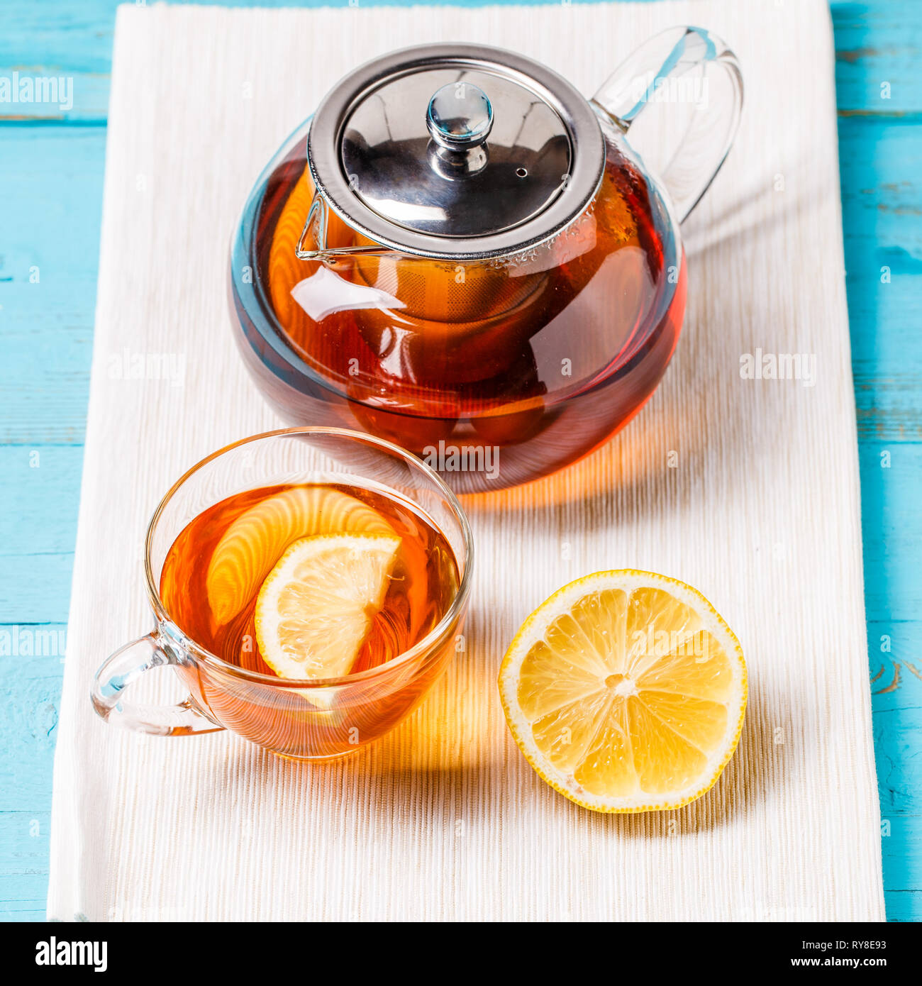 Glass cup of tea with lemon and glass teapot Stock Photo - Alamy