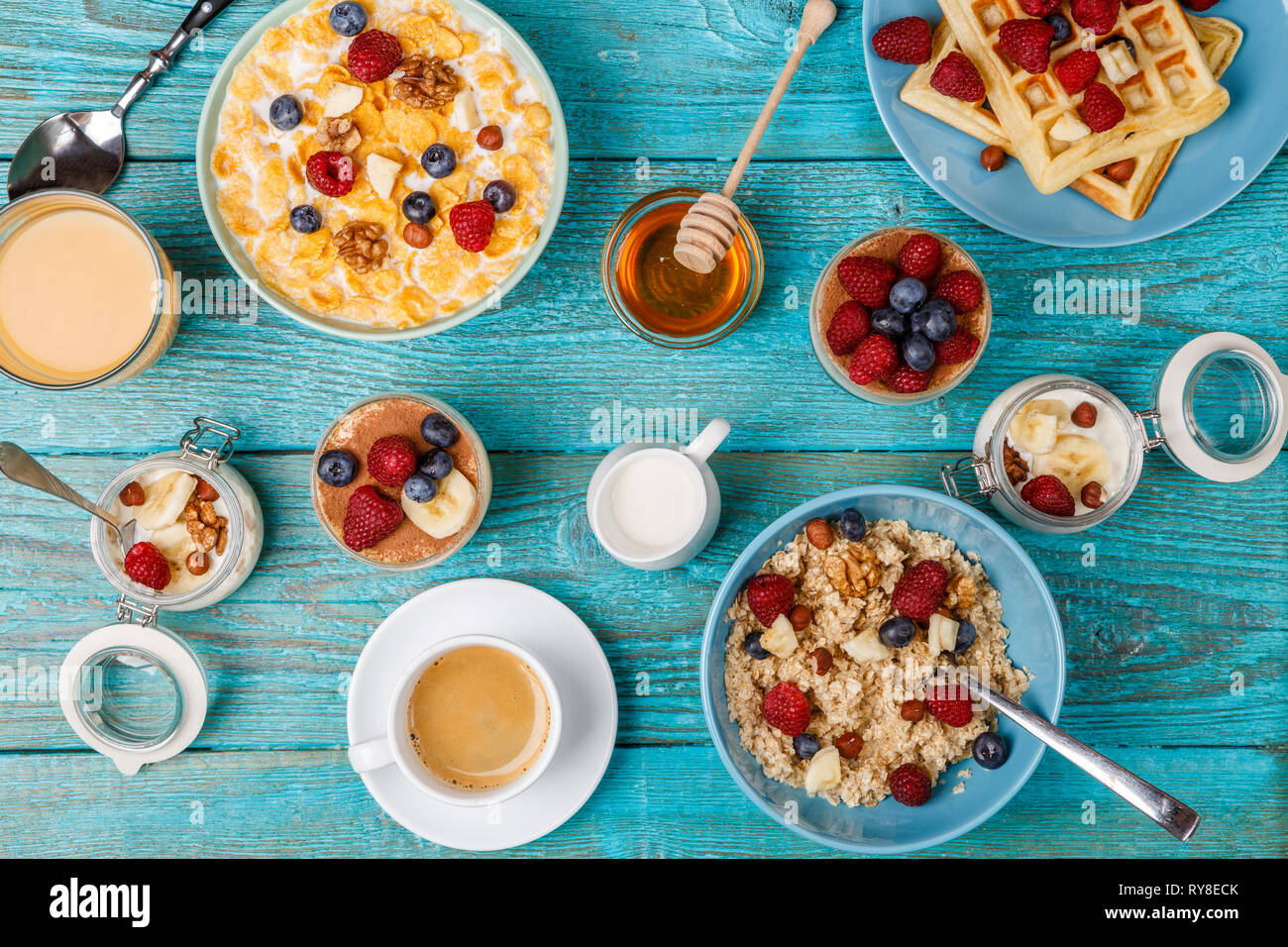 Breakfast table with waffles, oatmeal, cereals, coffee, juice and fresh ...