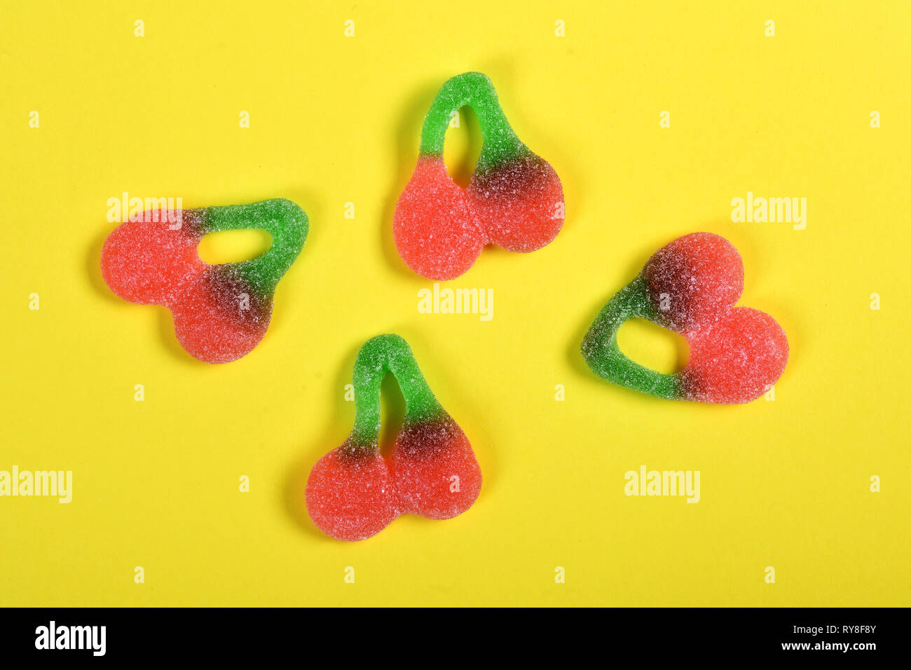 group of jelly candies cherries on yellow background Stock Photo - Alamy