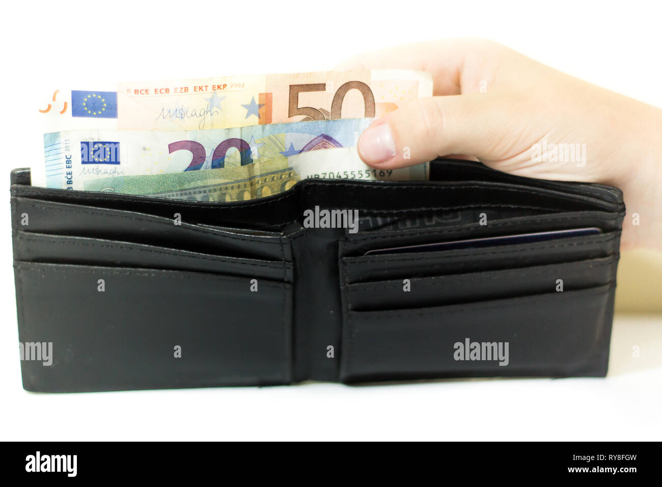A wallet with euro banknotes and coins inside. Money to pay the bills ...