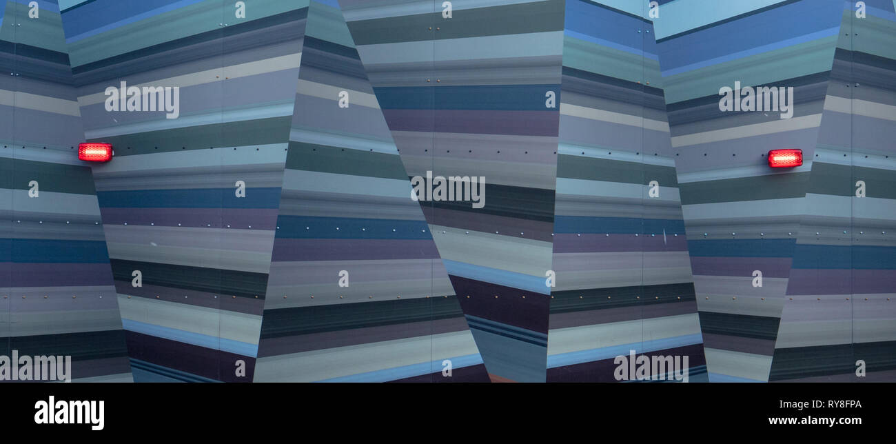 A colourful painted high wooden enclosure shielding and protecting a ...