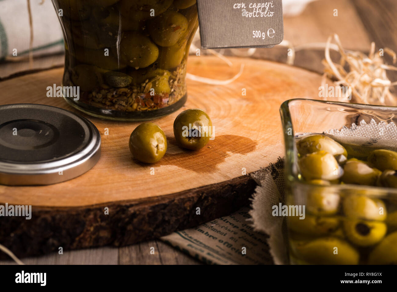 Bottle pouring virgin olive oil in a bowl close up Stock Photo - Alamy