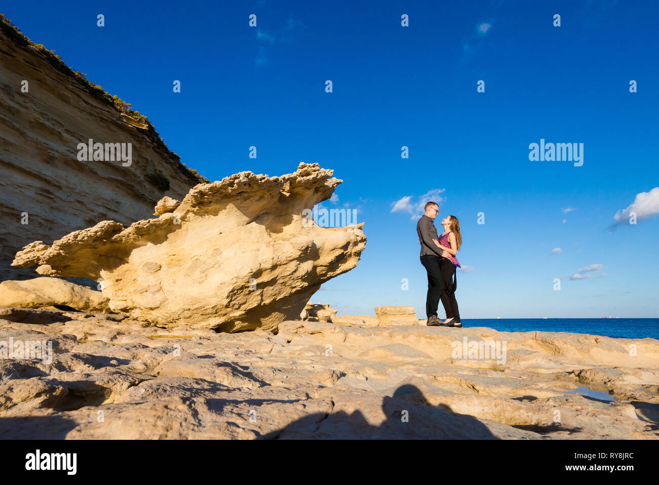 Young tourist on St Peter's Pool beach and lagoon on Malta island ...